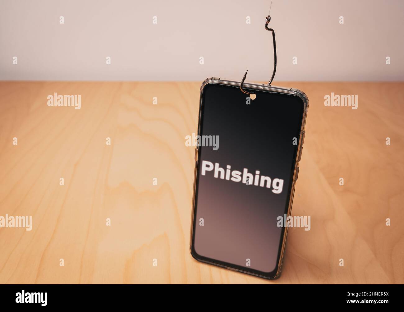 smartphone hanging on a fish hook Stock Photo - Alamy