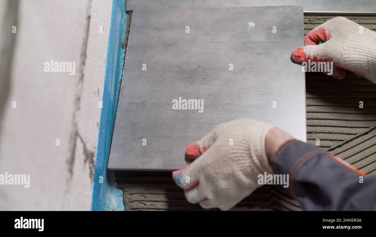 The process of laying ceramic tiles on the floor. Process of laying ...