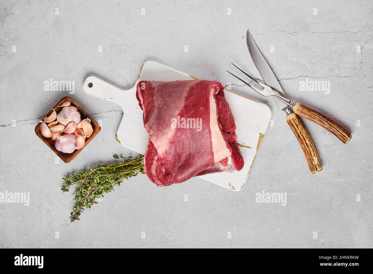 Raw beef rolled brisket boneless meat on white table Stock Photo - Alamy