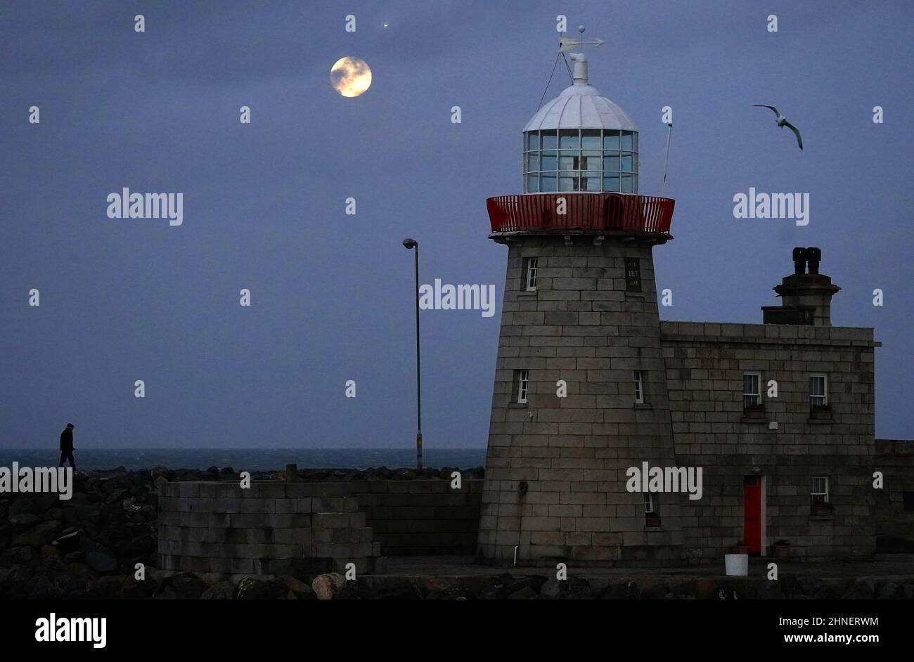 The full moon known as the 'Snow moon' rises above Howth lighthouse in ...