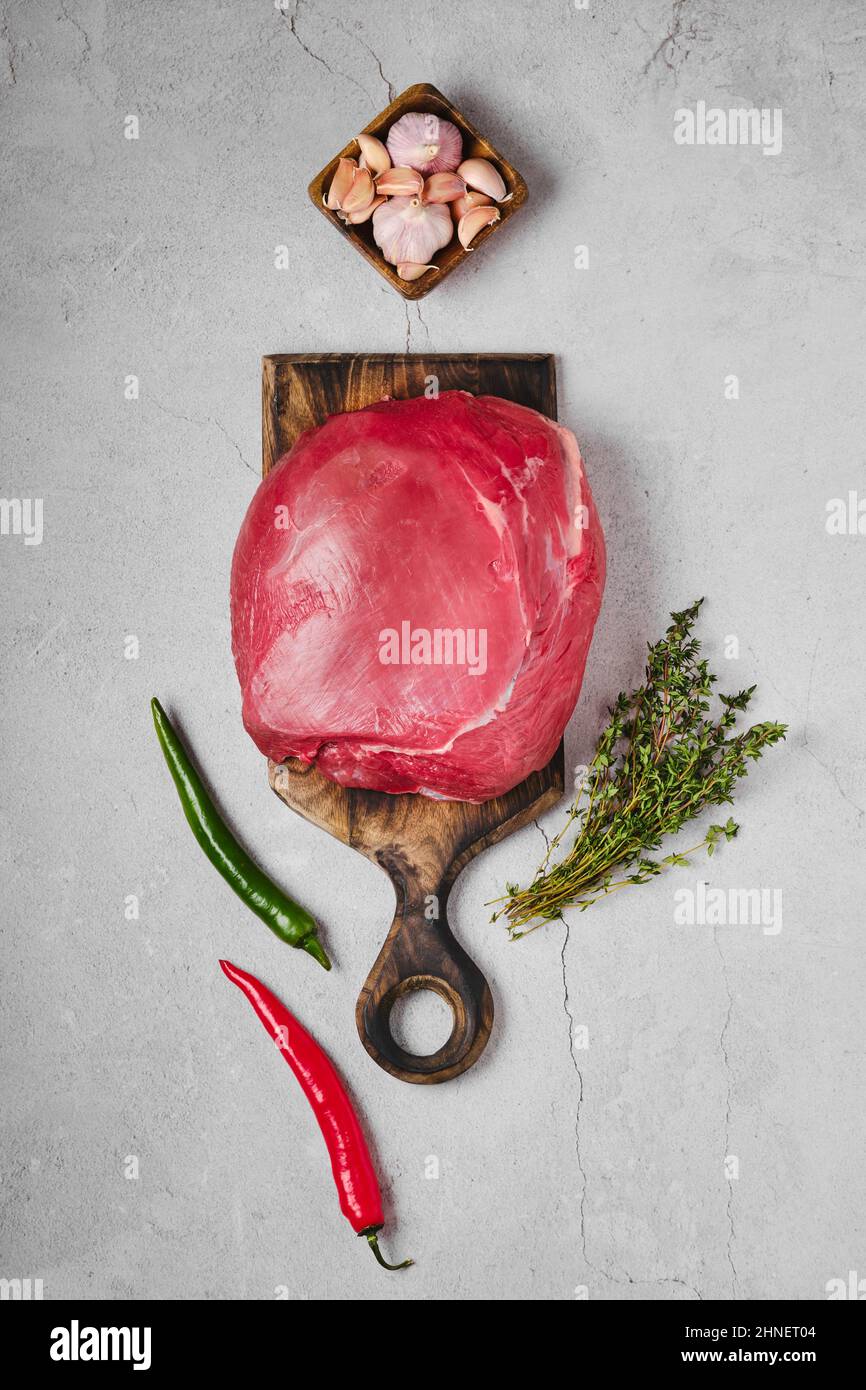 Top view of raw beef top round meat, whole uncut section on concrete ...