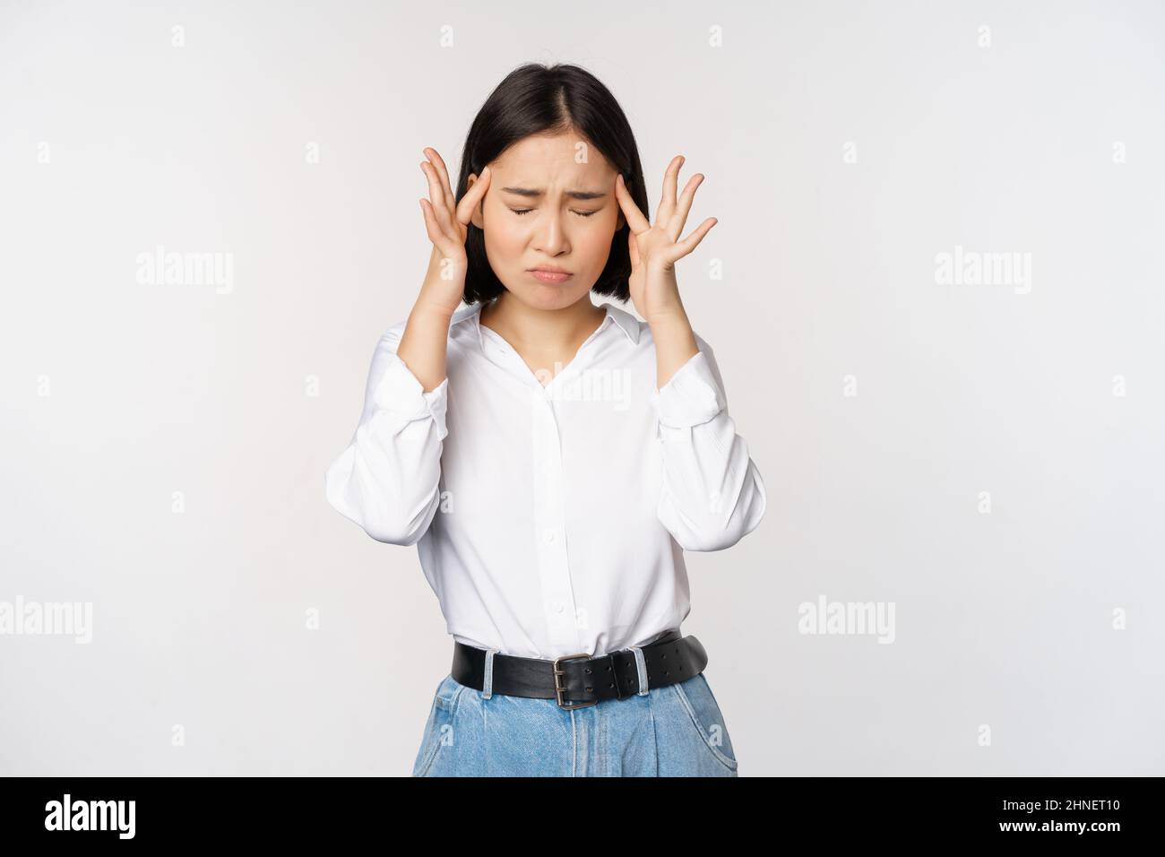 Image of distressed young asian businesswoman, female lady touching ...