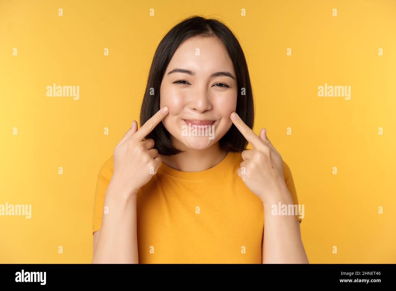 Close up portrait of cute asian girl showing her dimples and smiling ...