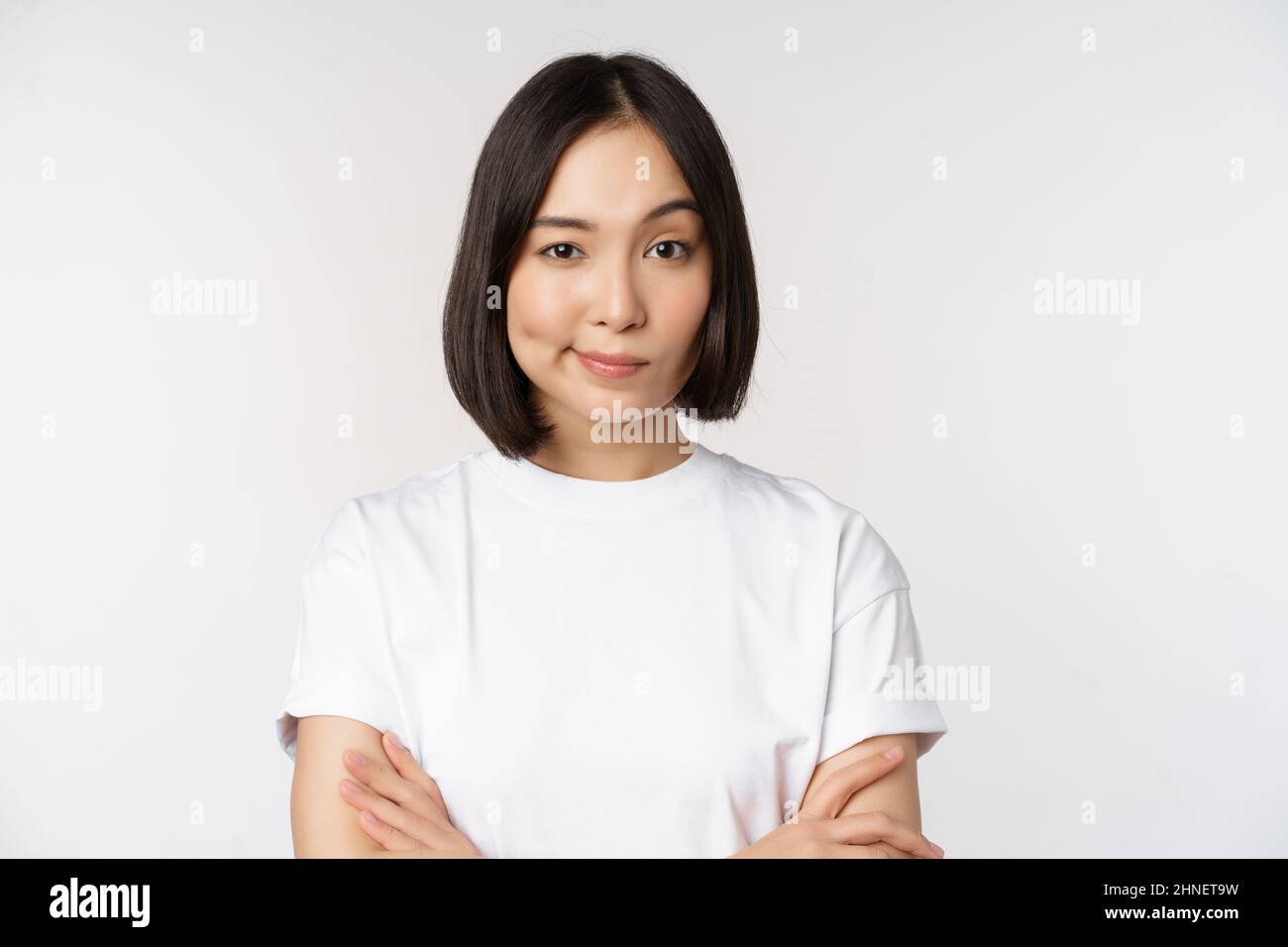 Close up of korean girl, looking skeptical, cross arms on chest and ...