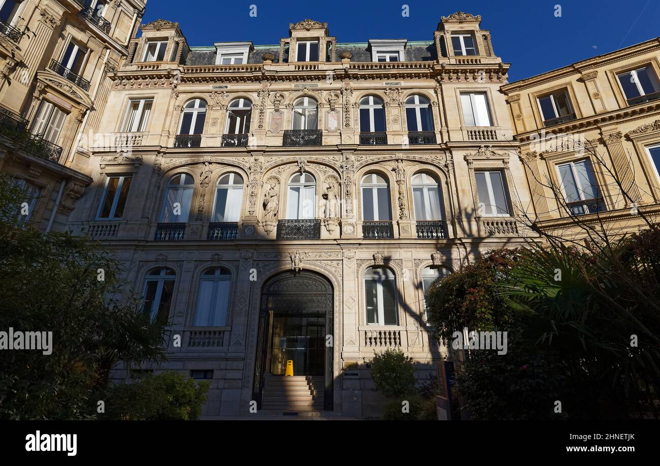 The facade of traditional French house with typical balconies and ...