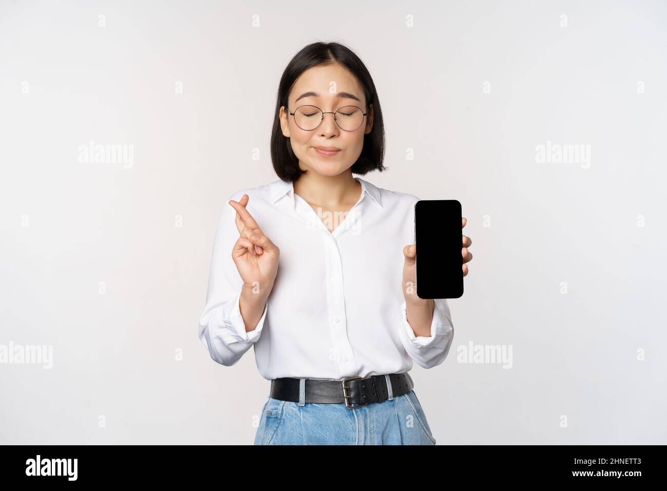 Hopeful young asian woman, showing mobile phone screen, app interface ...