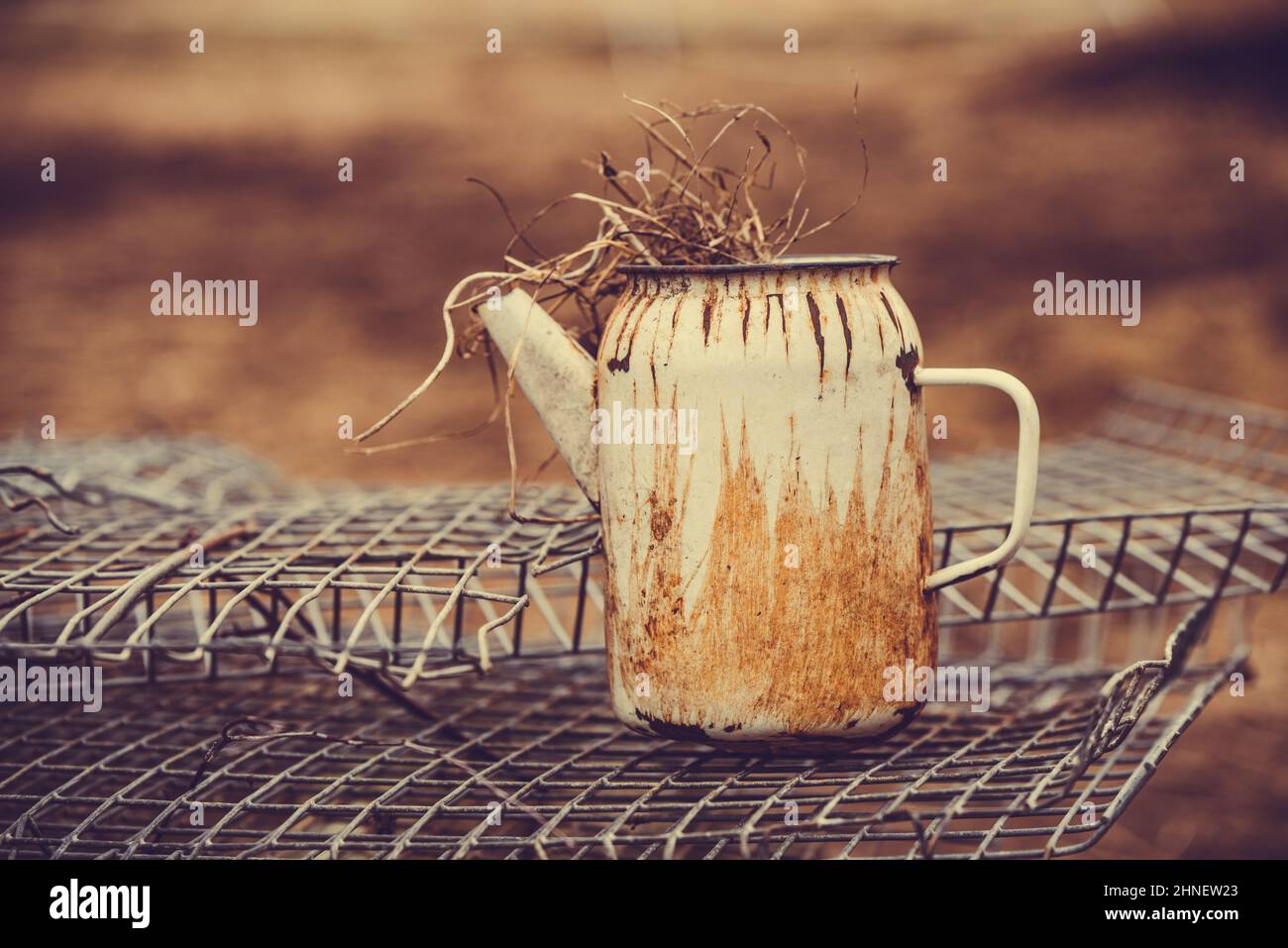 Old kettle stands on metal grid. A teapot Stock Photo - Alamy