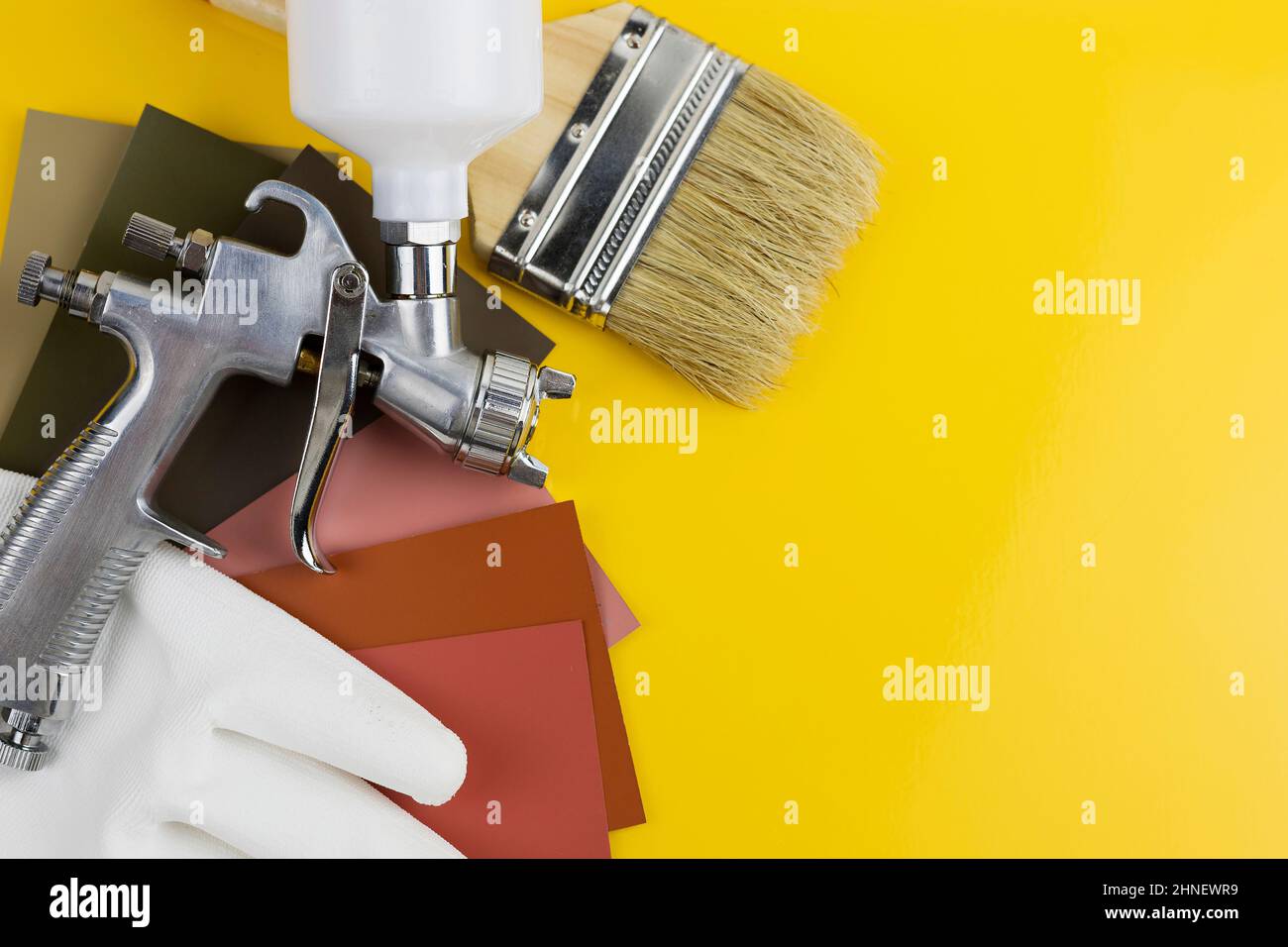 Paint spray gun at work at the workplace in the workshop. Paint Brush ...