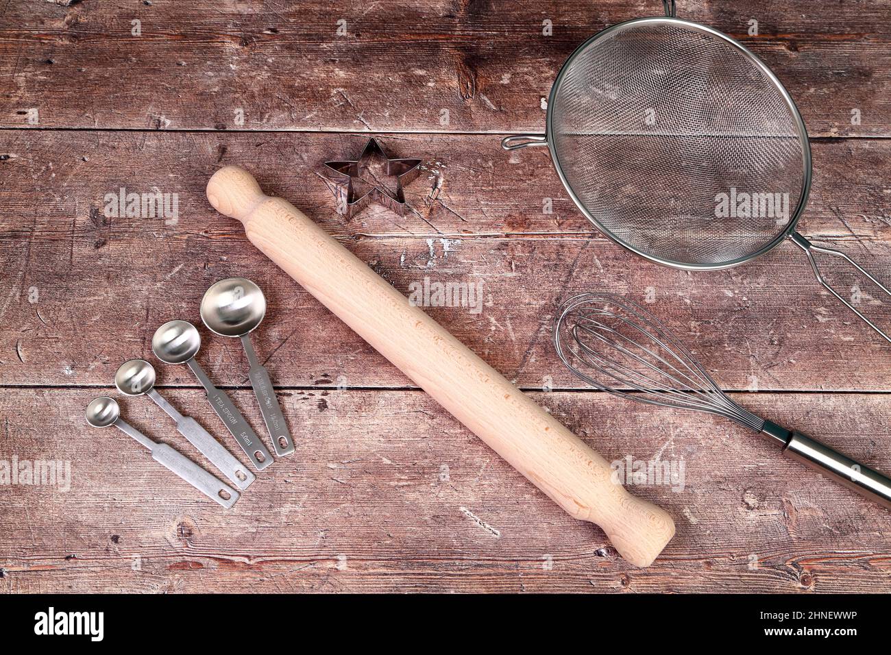 Wooden kitchen table with rolling pin,sieve,pastry cutter,whisk and ...