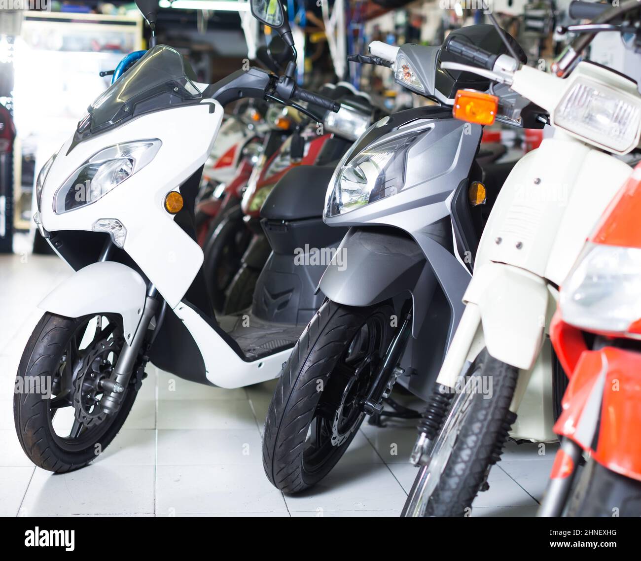 modern different colors motorbikes in the shop Stock Photo - Alamy