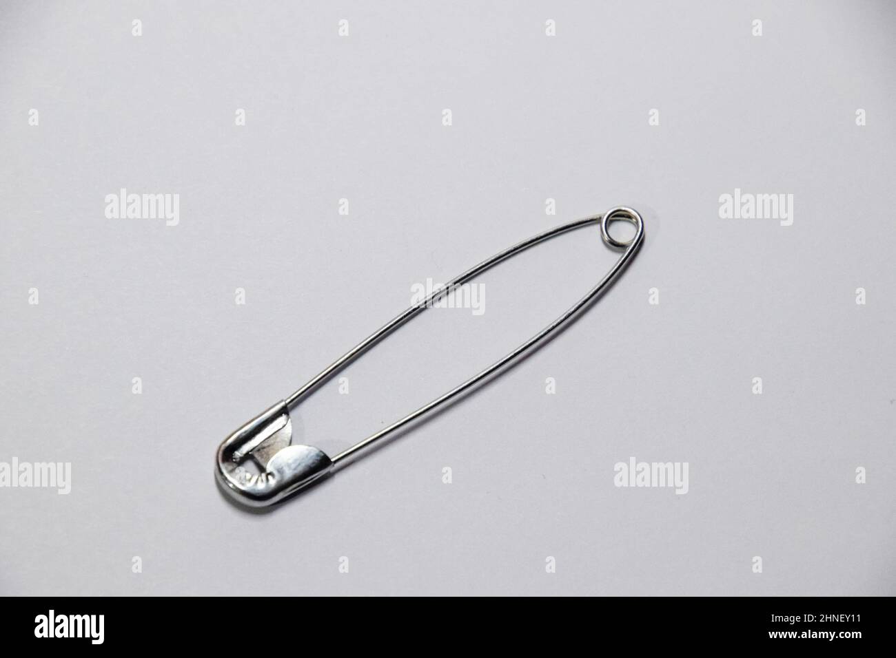 Pin on a white background. pin for fastening clothes Stock Photo - Alamy