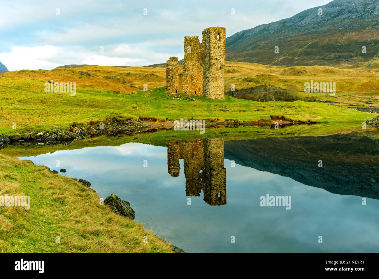 The ruins of Ardvreck Castle reflected in the water of Loch Assynt ...