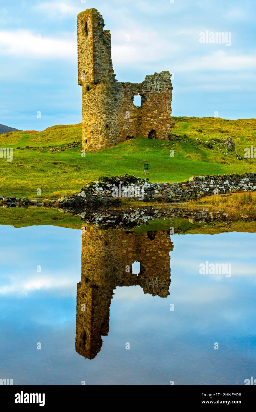 The ruins of Ardvreck Castle reflected in the water of Loch Assynt ...