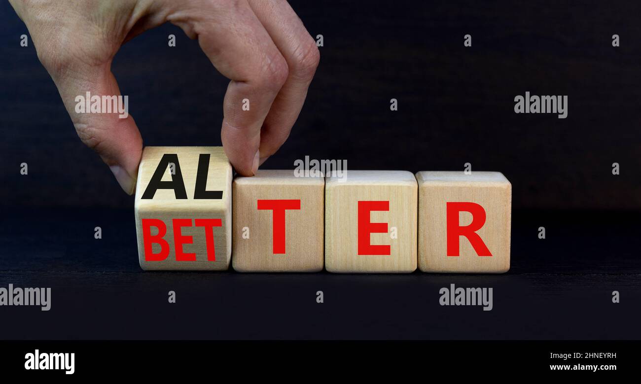 Alter or better symbol. Businessman turns wooden cubes and changes the ...