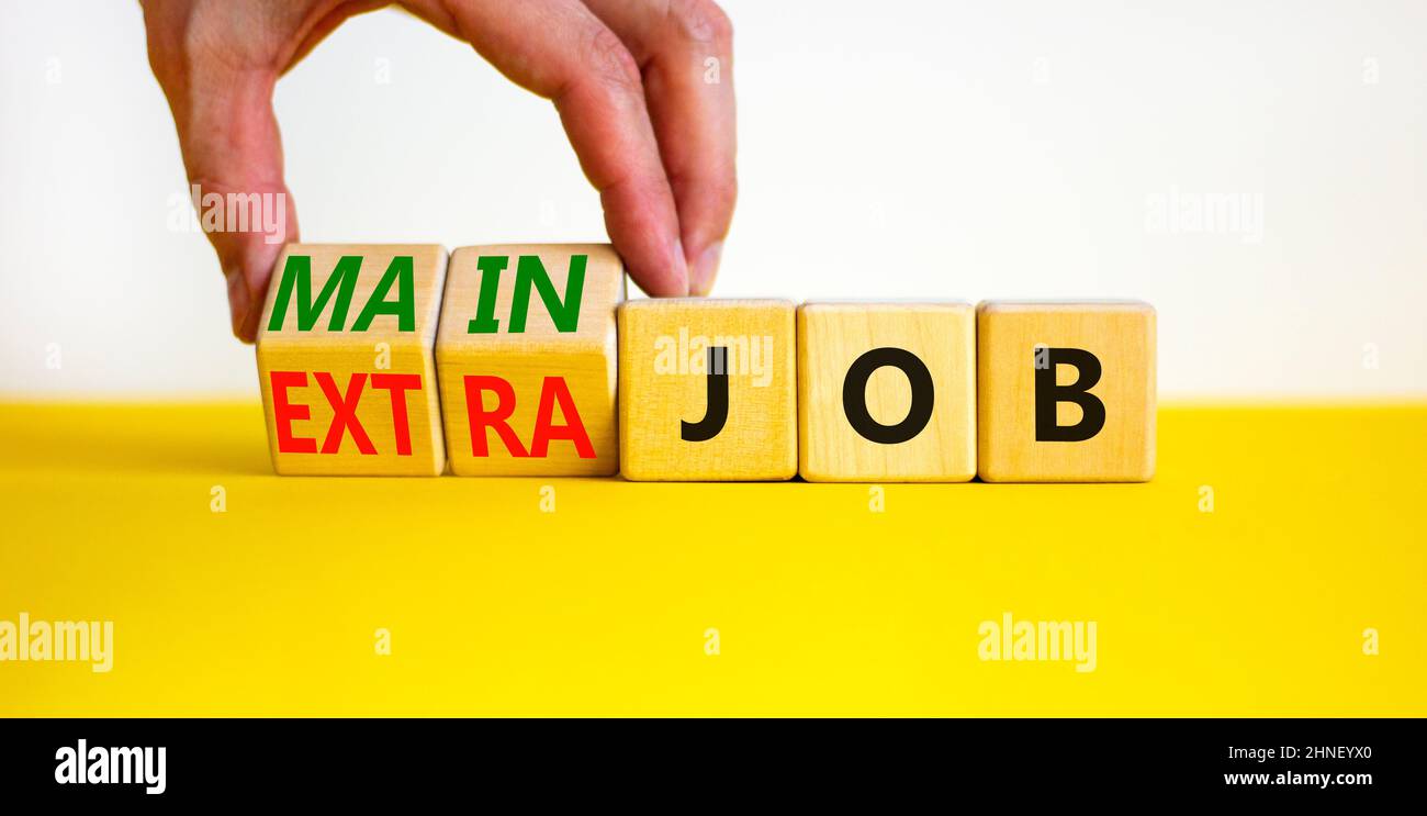 Extra or main job symbol. Businessman turns wooden cubes and changes ...