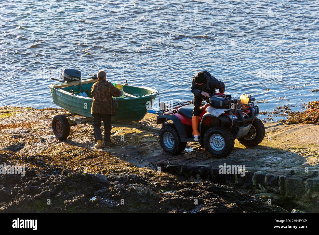 Two men launching a boat hi-res stock photography and images - Alamy