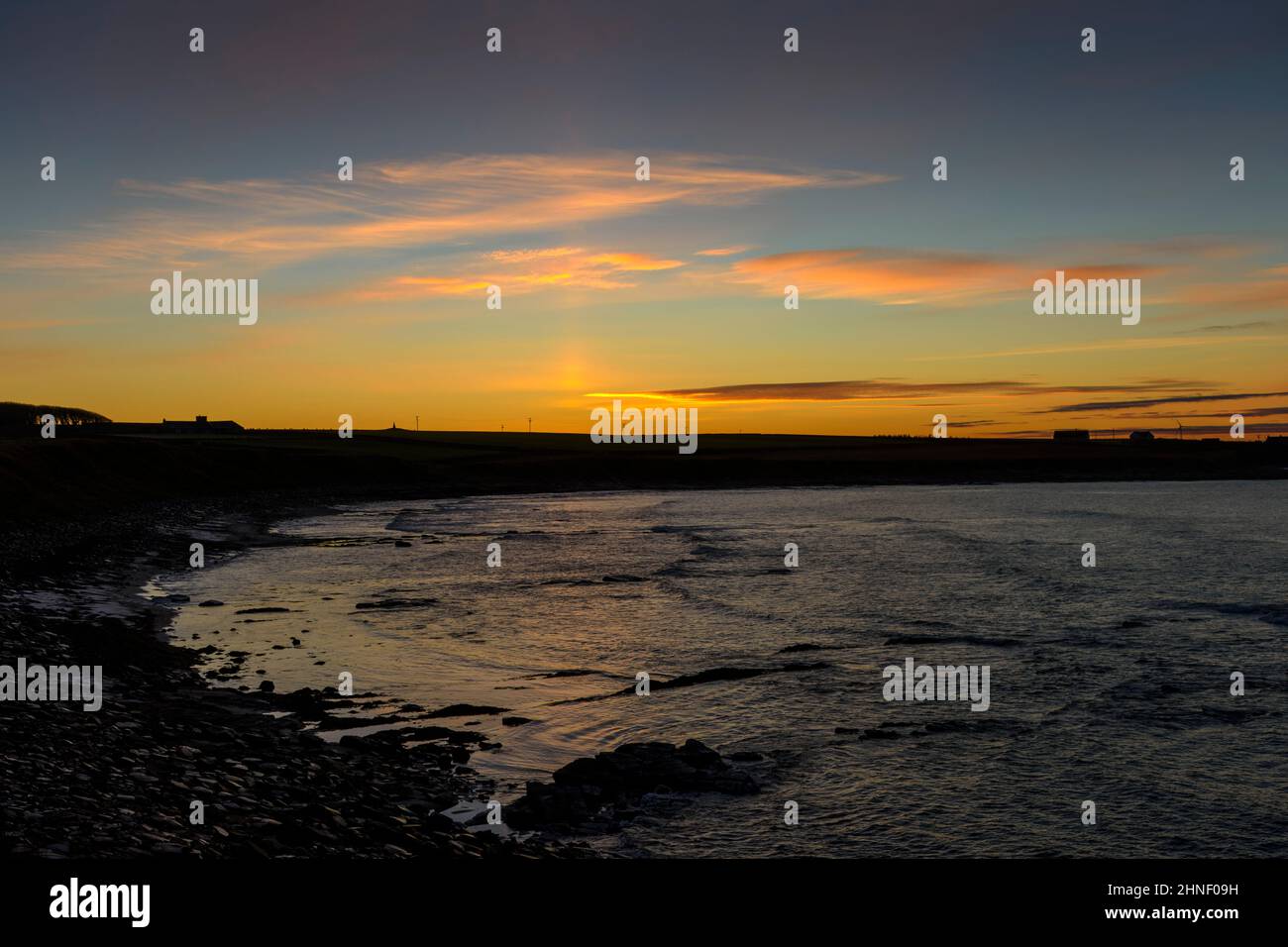 Sunset with a sun pillar, also called a solar pillar, from the beach ...