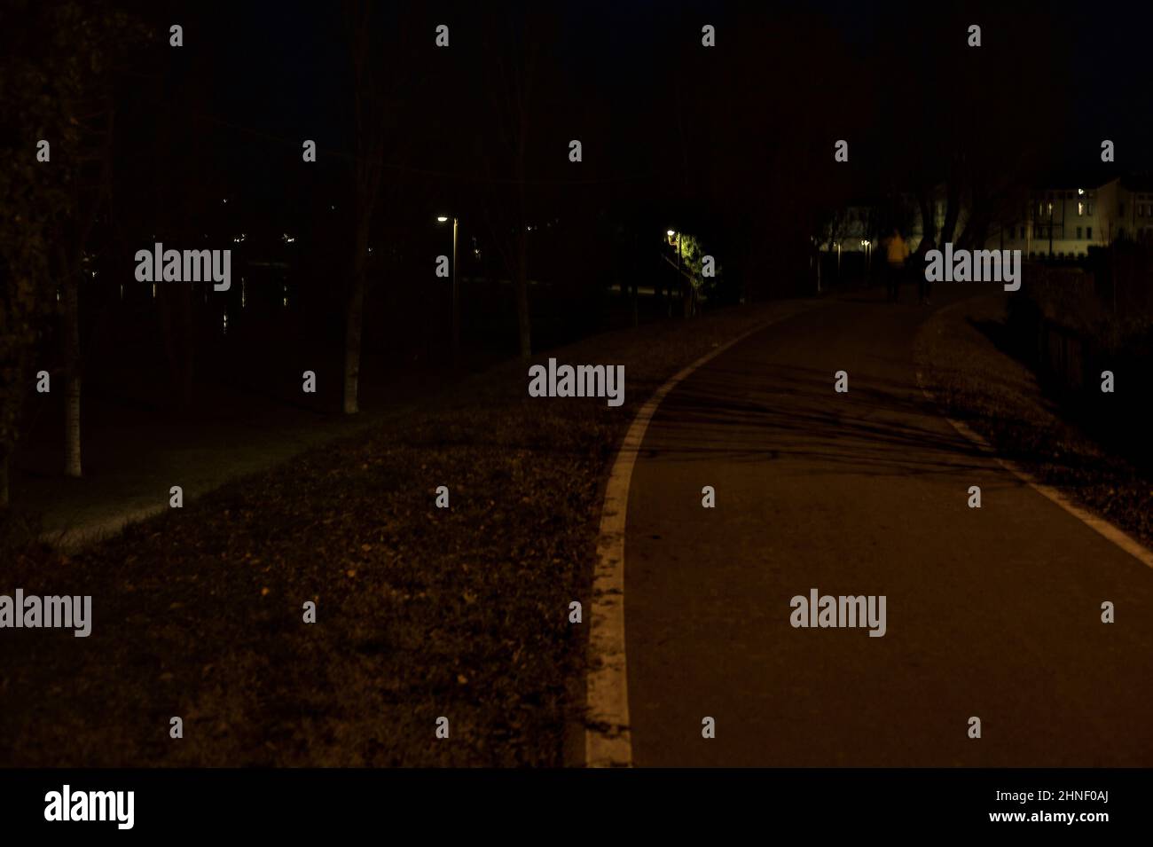 Road on the top of an embankment in a park at night Stock Photo - Alamy