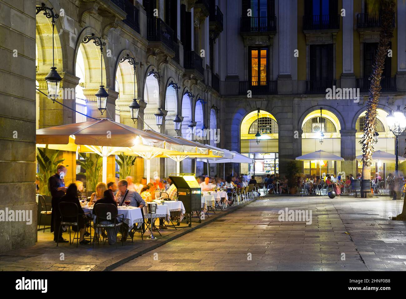 Illuminated Placa Reial in Barcelona Stock Photo - Alamy