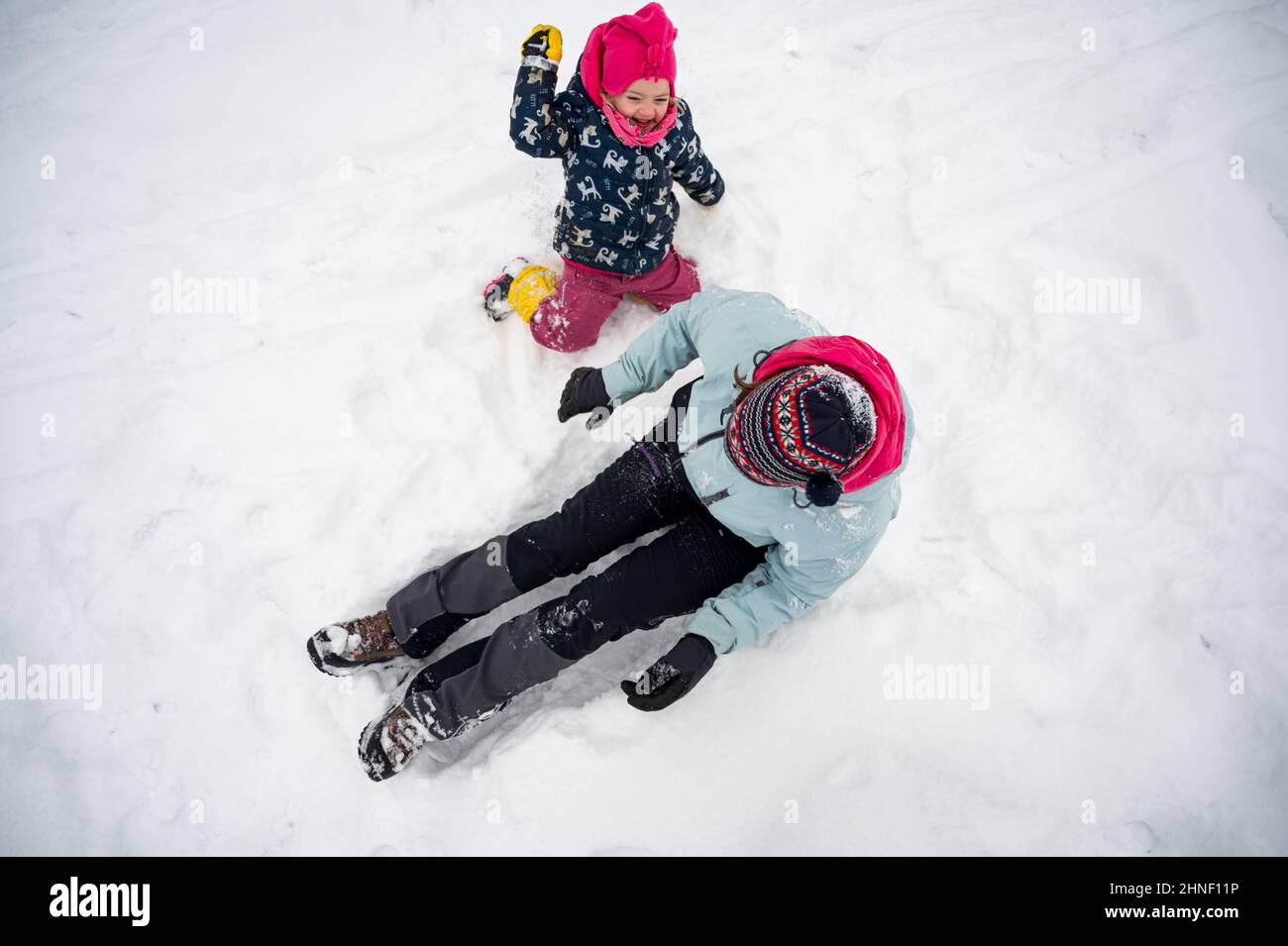 Mother and daughter having fun in the snow Stock Photo - Alamy