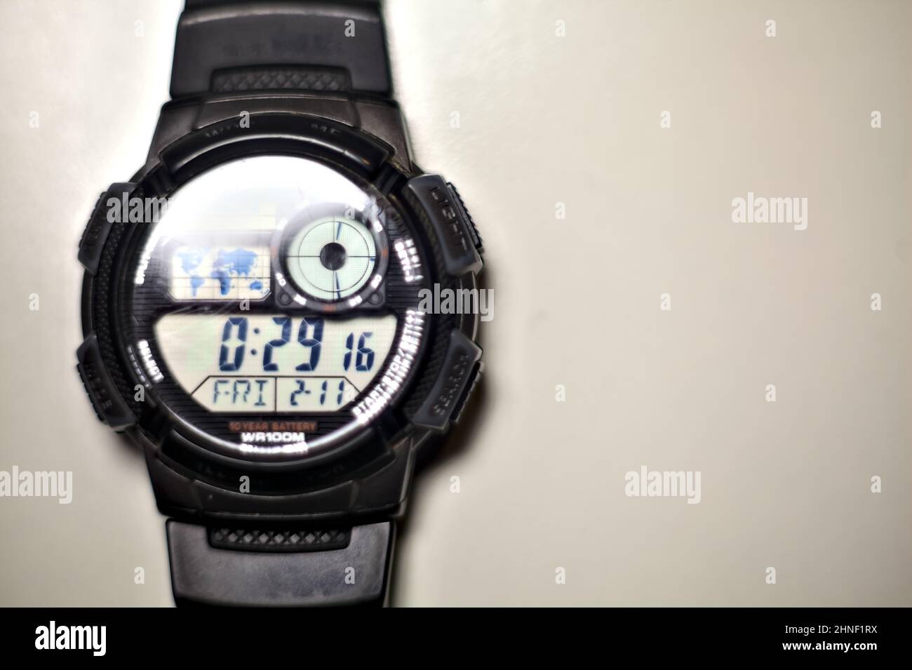 Wrist watch lit by a bright light on a desk seen up close Stock Photo ...