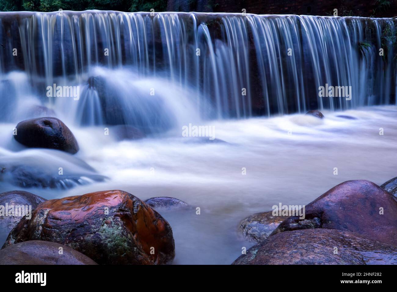 Beautiful view of the heavy waterfall and the huge stones in the water ...