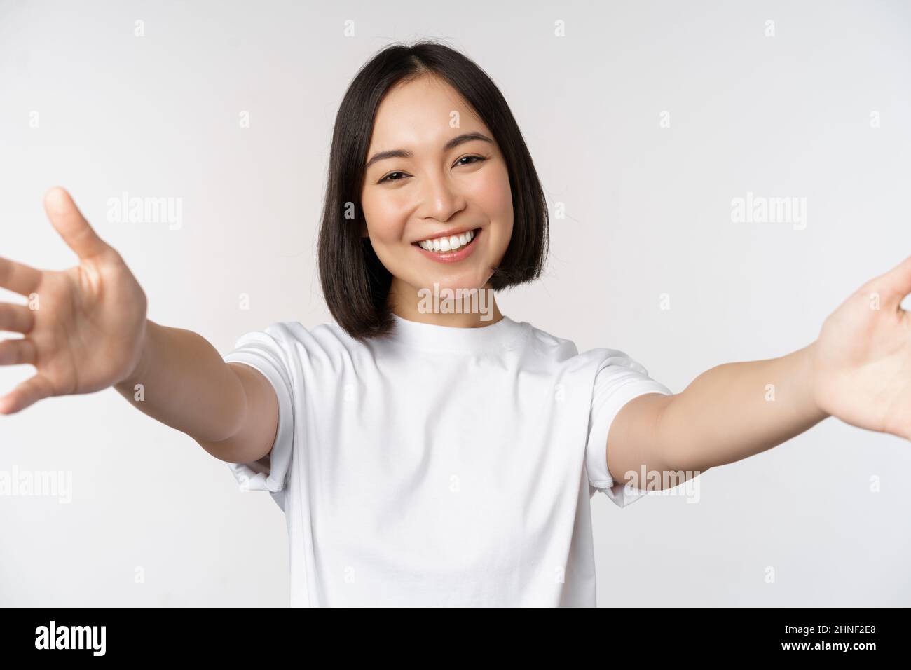 Close up of happy smiling korean woman reaching hands, hugging ...