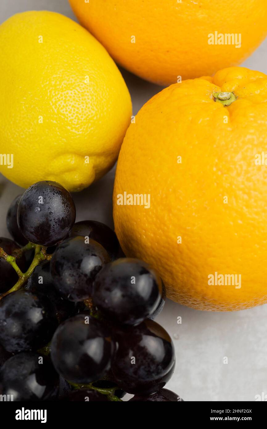 fresh fruits, lemon, orange, grapes on a light background. Close-up ...