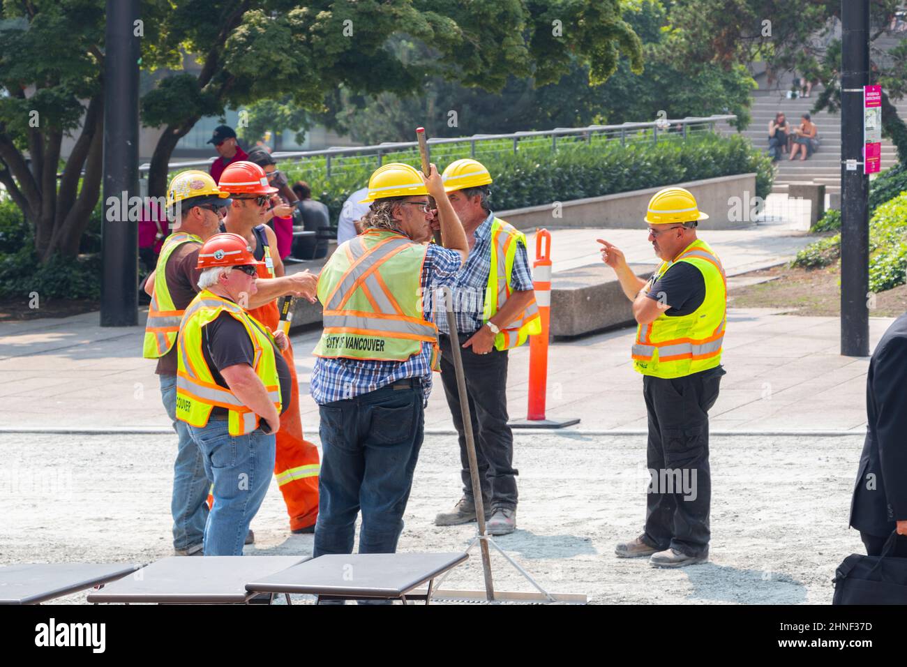 group of construction workers huddling in a discussion Vancouver canada ...