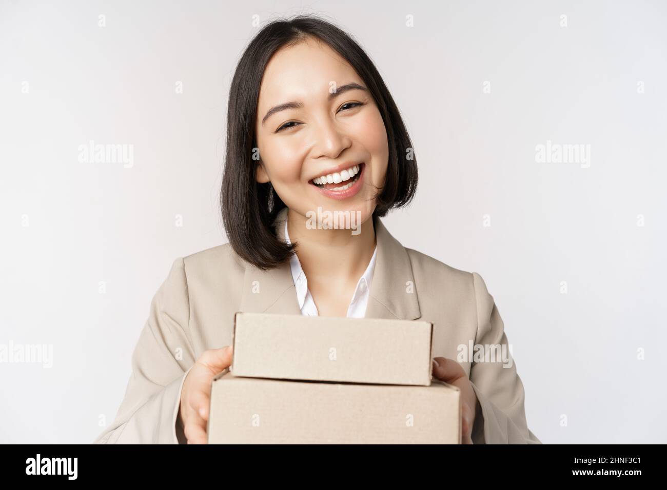 Image of asian saleswoman, business woman giving boxes with order ...