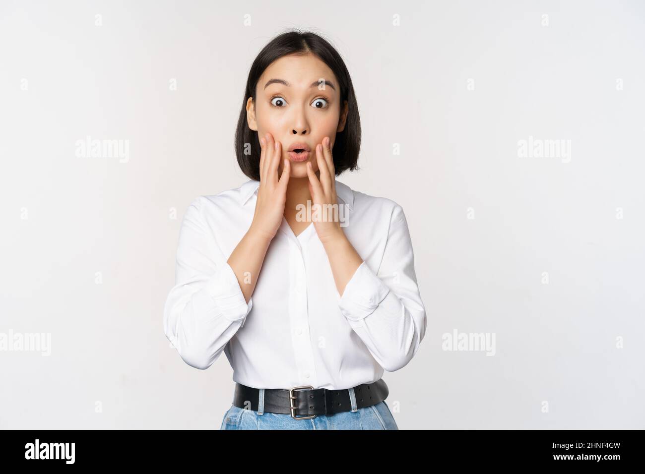 Image of asian female model looking surprised, staring amazed, reacting ...