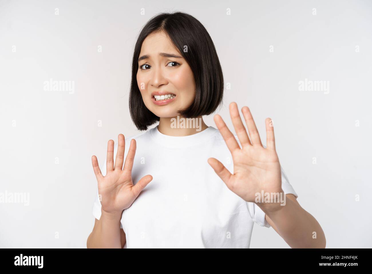 Disgusted asian woman rejecting smth, grimacing from dislike and ...