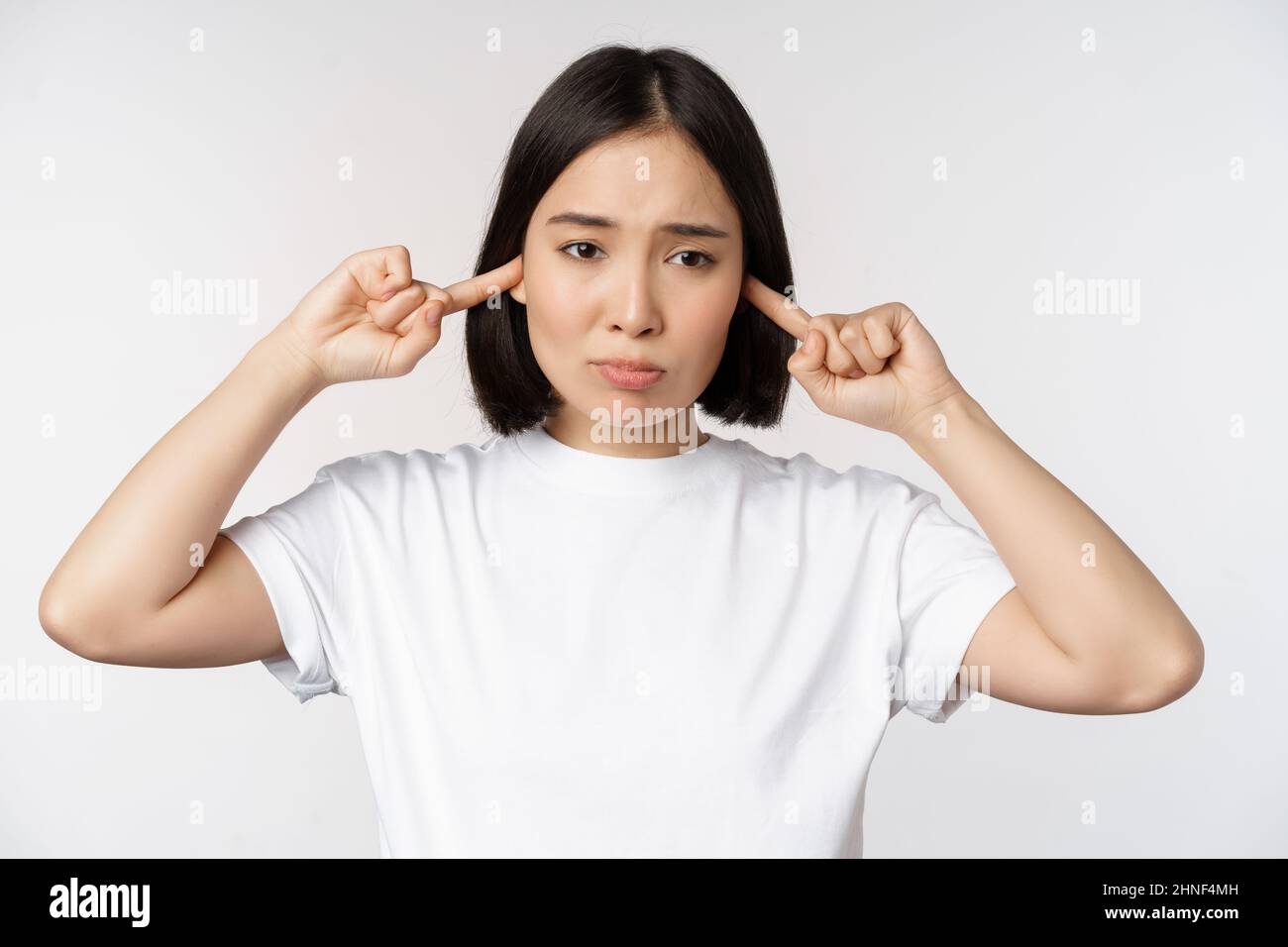 Portrait of asian woman shut ears and feeling discomfort from loud ...