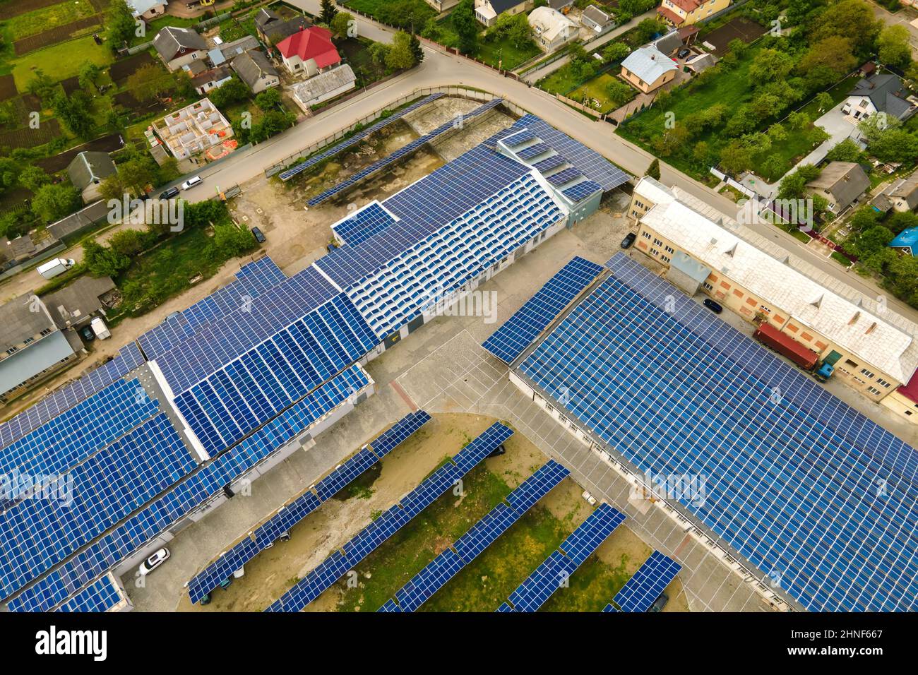 Aerial view of blue photovoltaic solar panels mounted on industrial ...