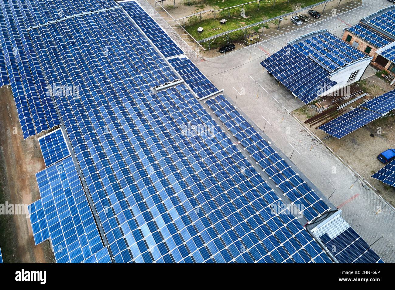 Aerial view of blue photovoltaic solar panels mounted on industrial ...