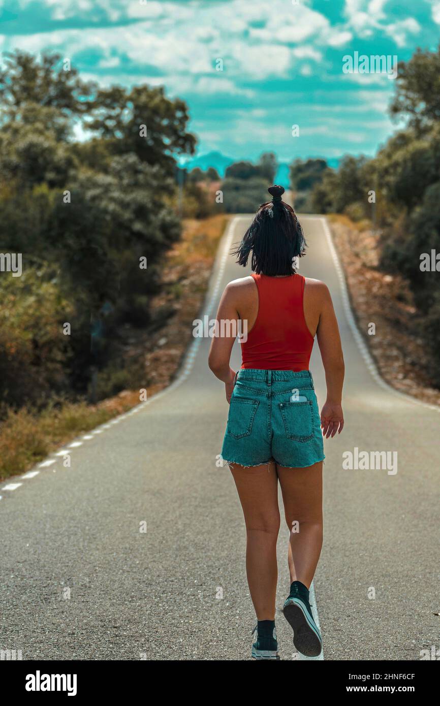 Woman alone on beautiful empty country bend, asphalt road Stock Photo ...