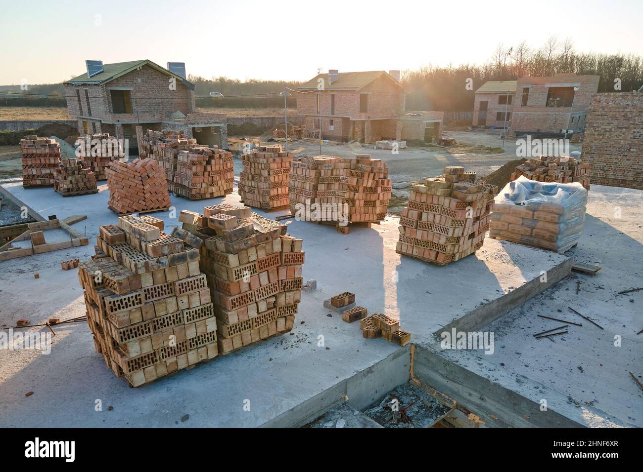 Aerial view of new homes with brick framework walls under construction ...