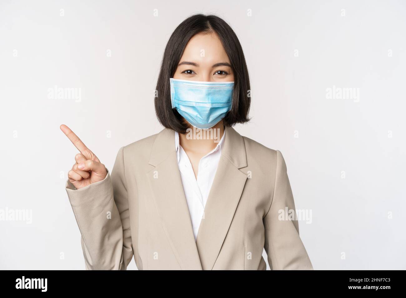 Coronavirus and work concept. Portrait of woman in medical face mask ...