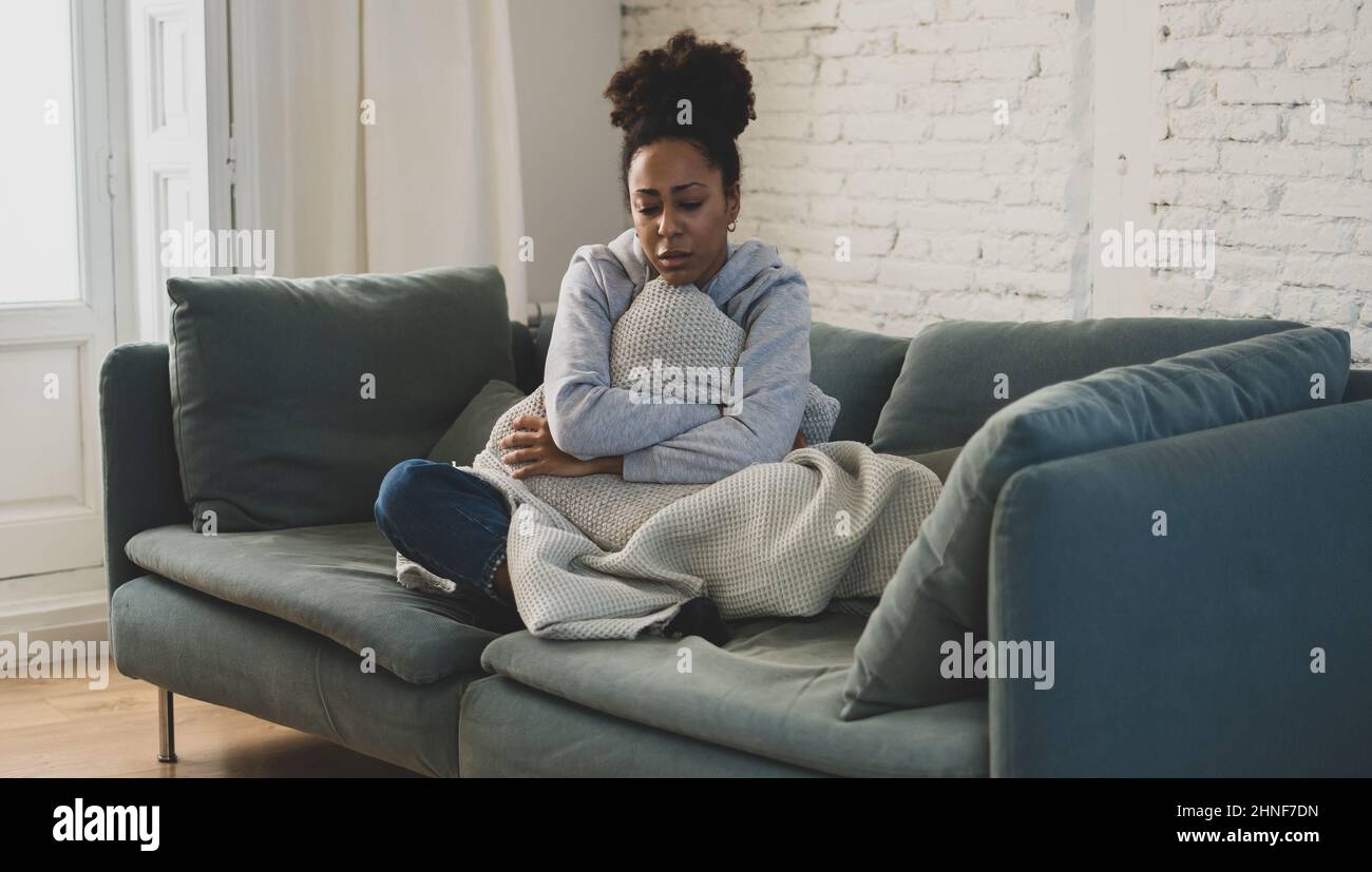 Young attractive african american woman lying at home living room couch ...