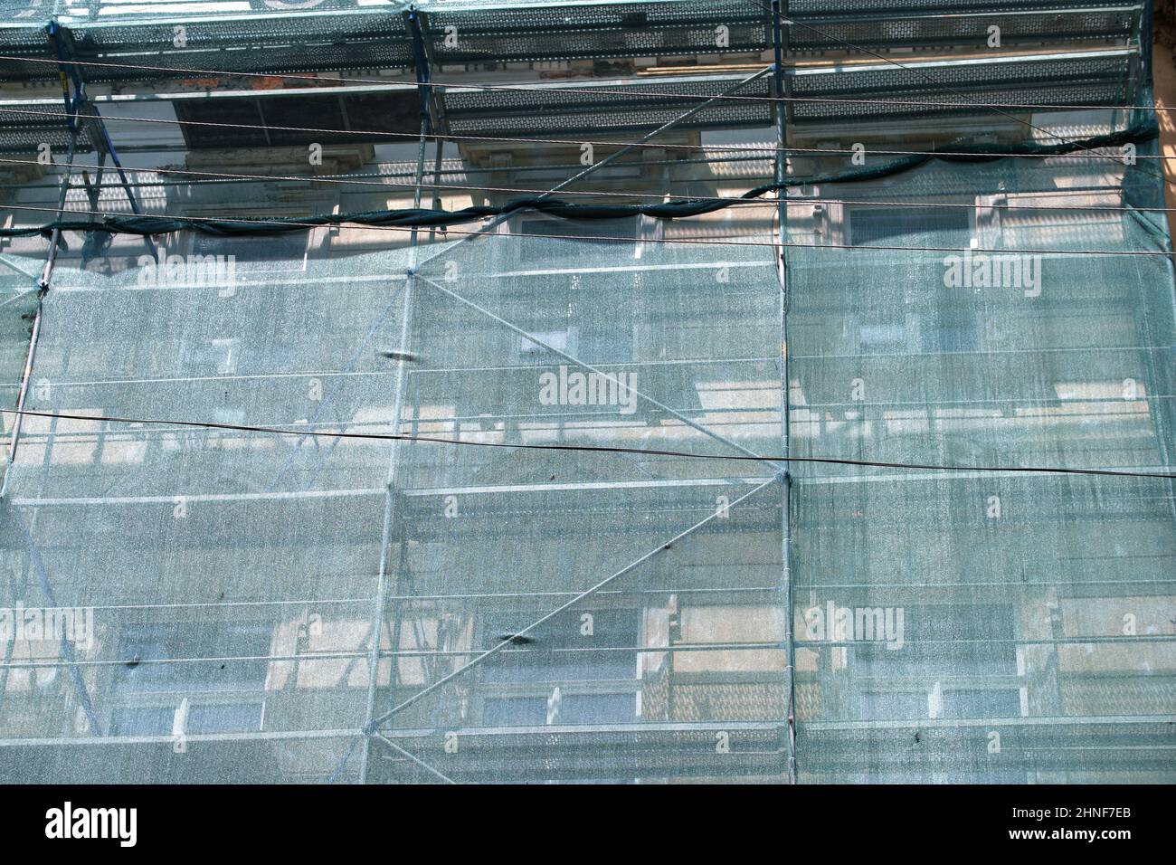 Building facade under renovation works with construction scaffolding ...