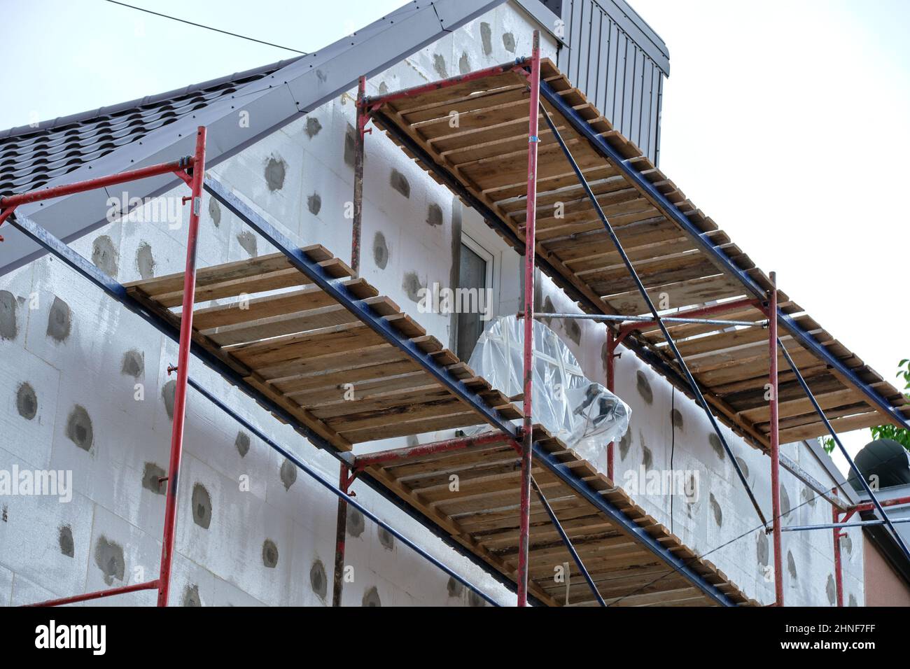 Building facade under renovation works with construction scaffolding ...