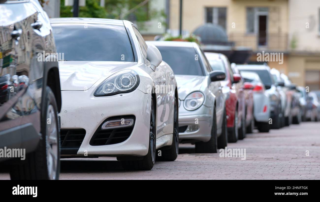 Cars parked in line on city street side. Urban traffic concept Stock ...
