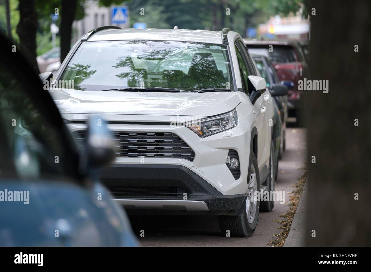 Cars parked in line on city street side. Urban traffic concept Stock ...