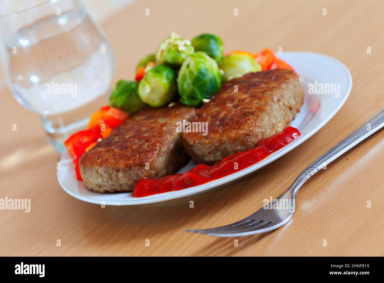 Two fried cutlets with vegetables Stock Photo - Alamy