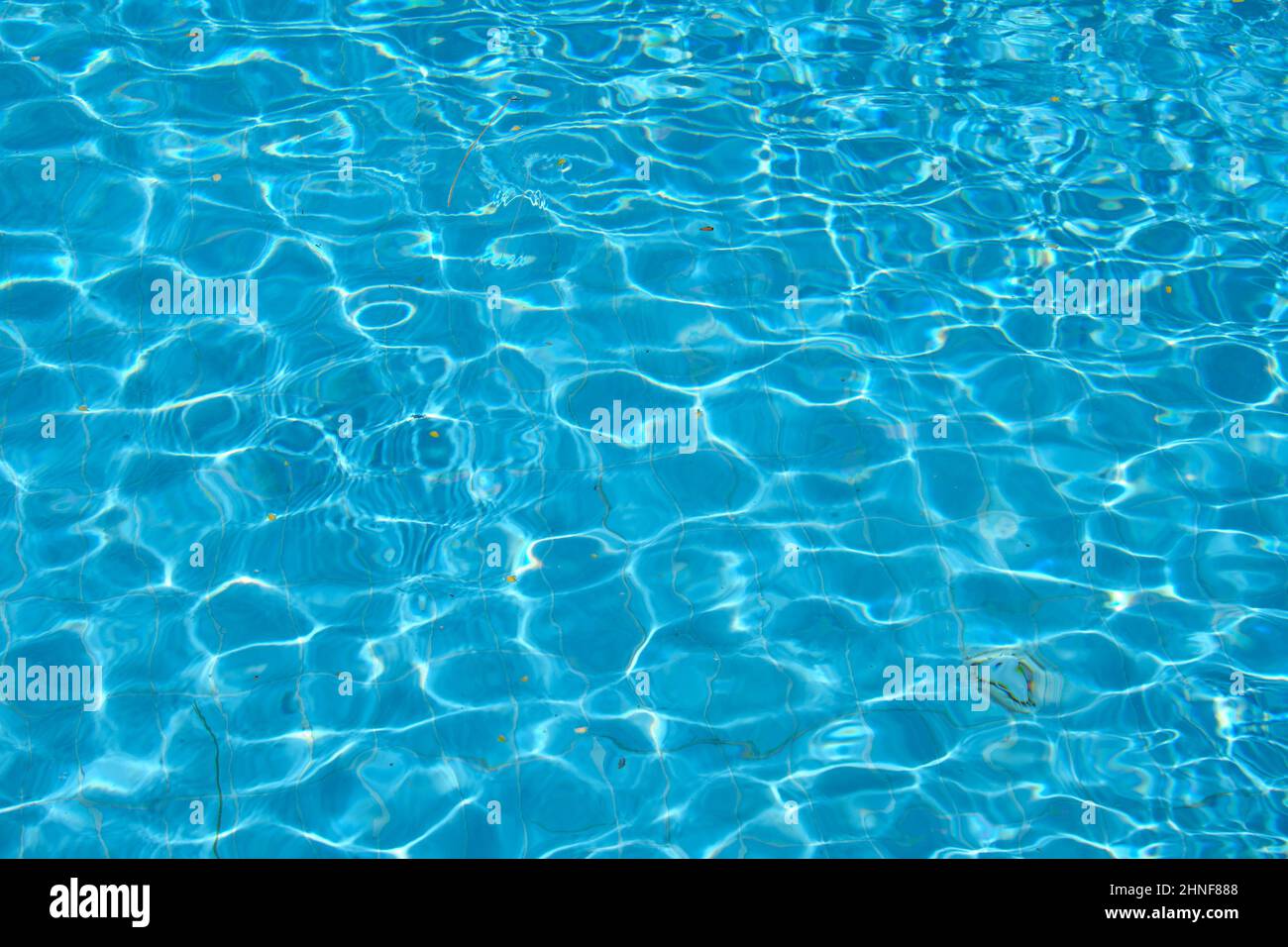 Closeup surface of blue clear water with small ripple waves in swimming ...
