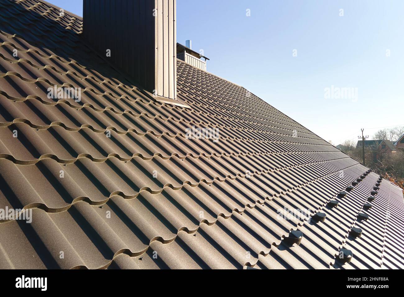 Closeup snow guard for safety in winter on house roof top covered with ...