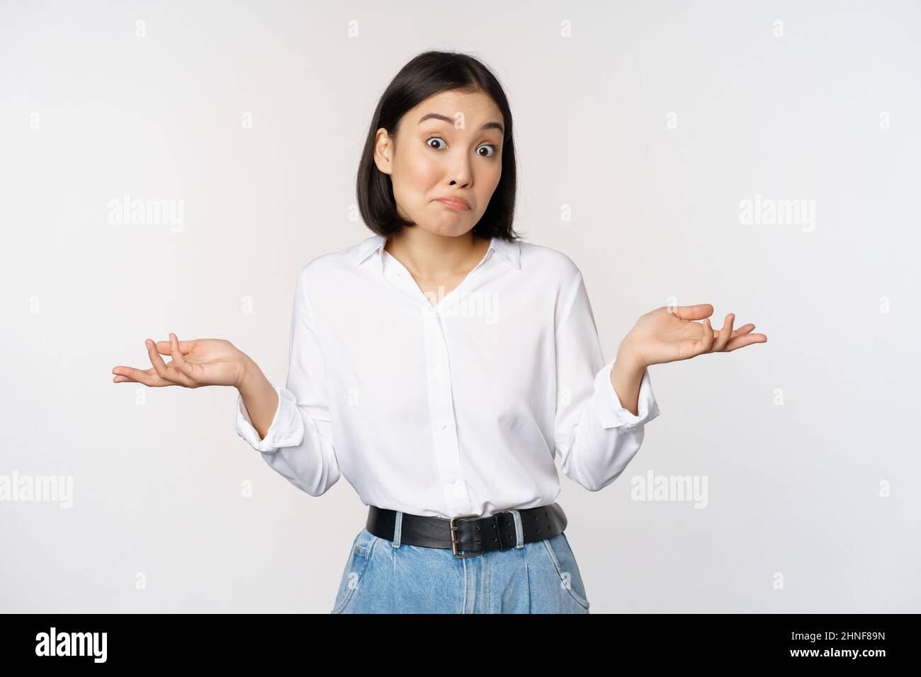 Image of confused asian office manager, office lady shrugging shoulders ...