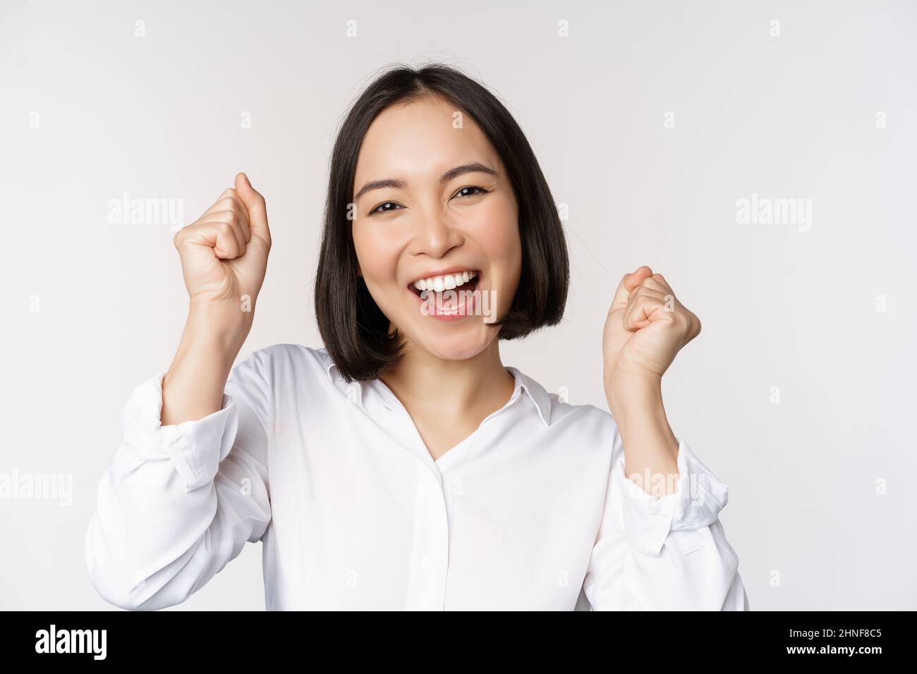 Close up face portrait of dancing asian woman smiling, triumphing and ...
