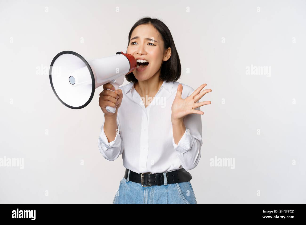 Image of young woman, korean activist, recruiter screaming in megaphone ...