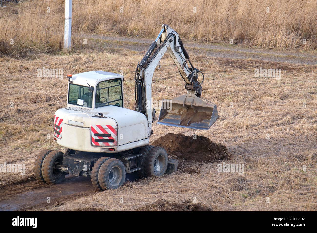 Earth moving tractor preparing place for future house foundation ...